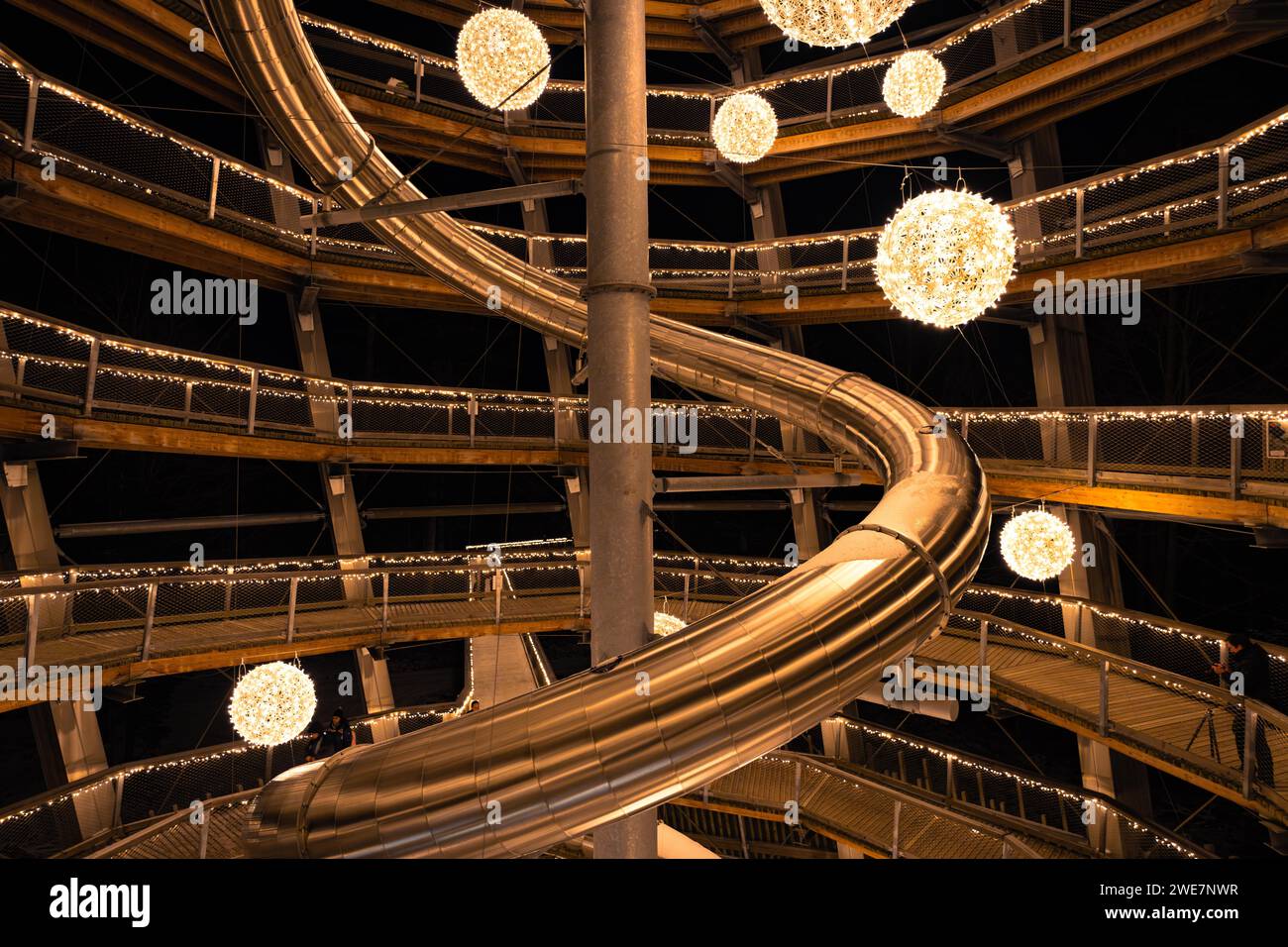 Shiny slide in a nocturnal wooden construction with lights, magical ...
