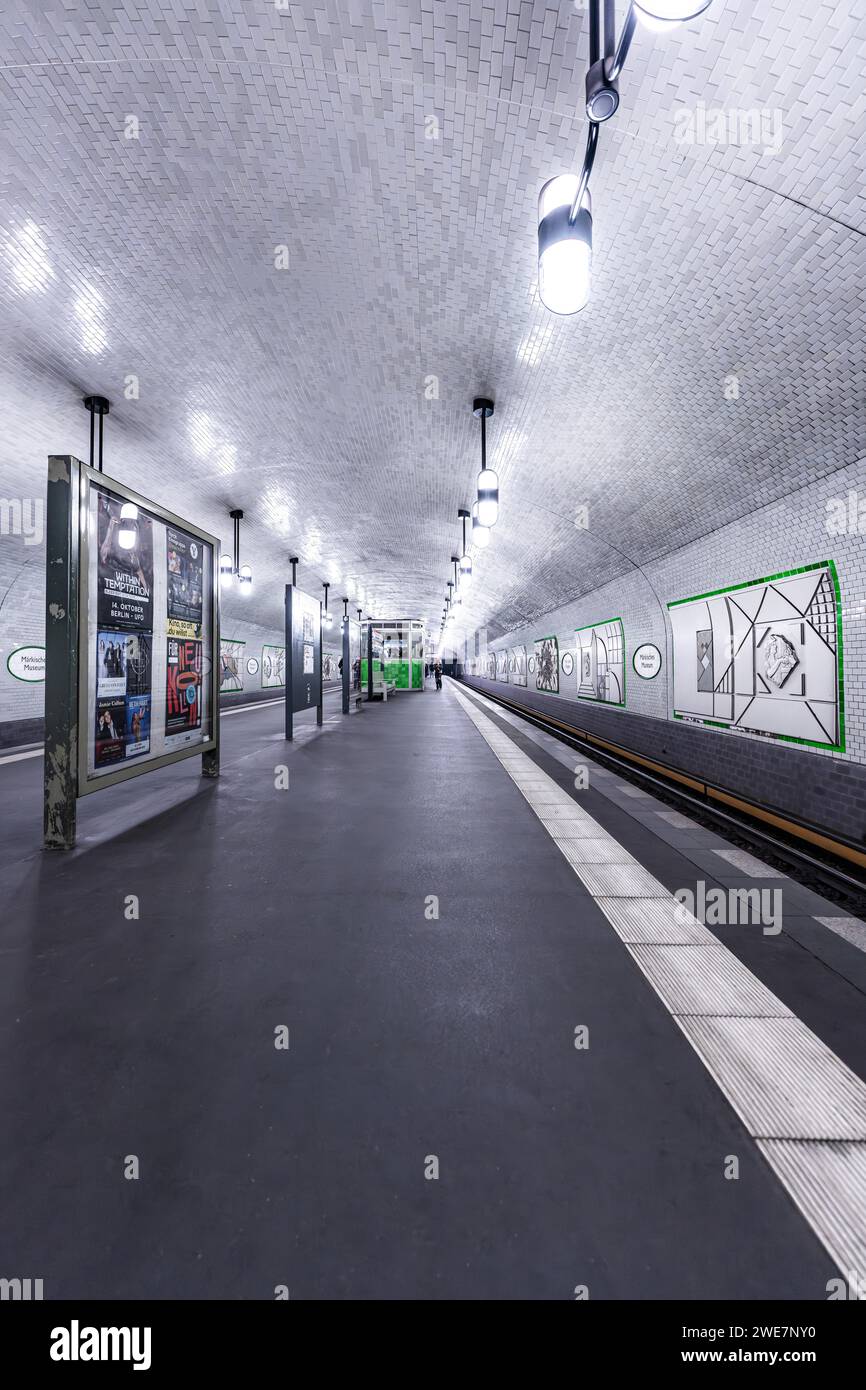 Empty underground station with white tiles and modern design under ...