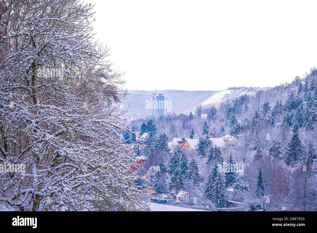View of the snow-covered Jentower in Jena with mountains and forests in ...