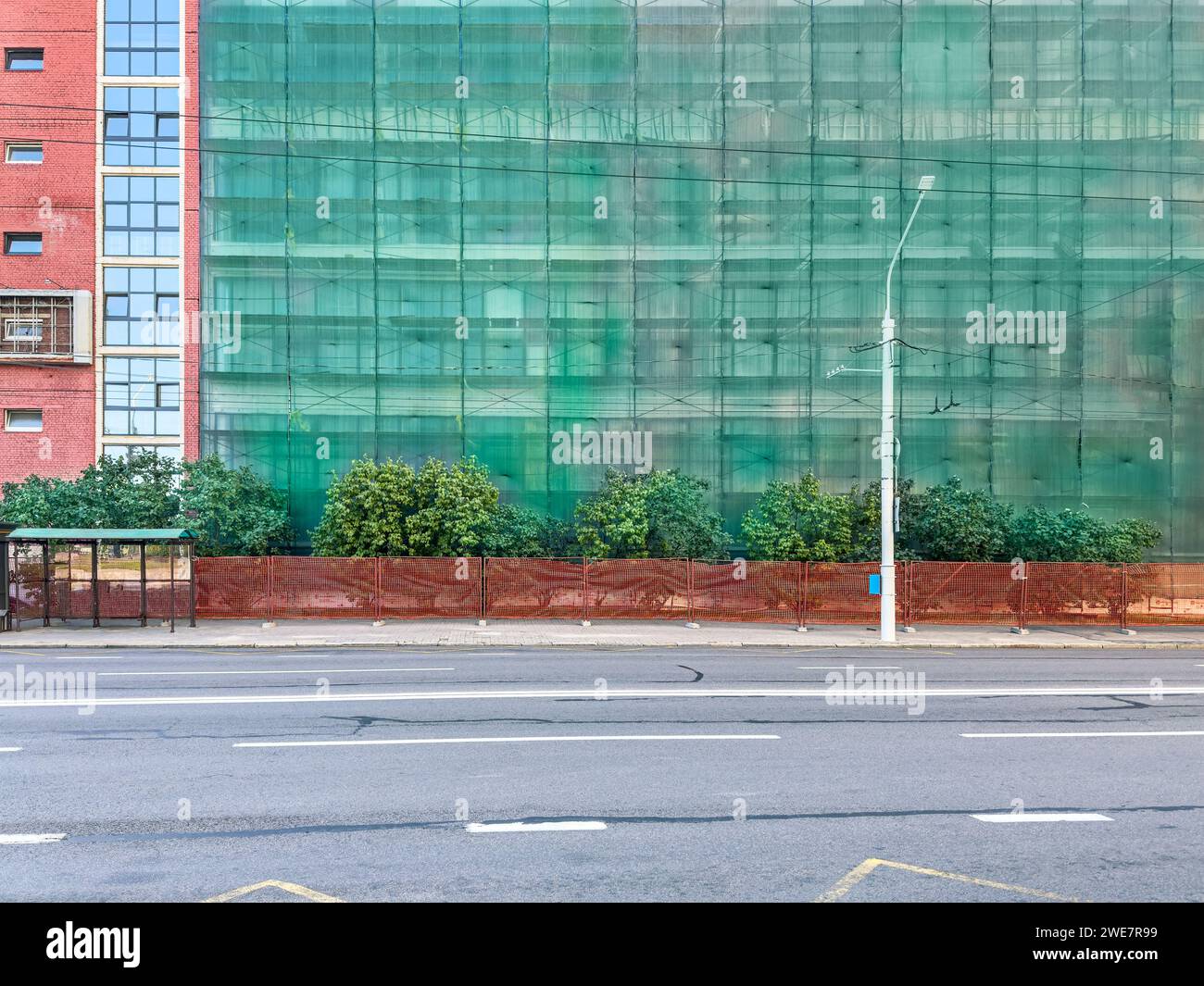industrial building facade under renovation. building is covered with ...