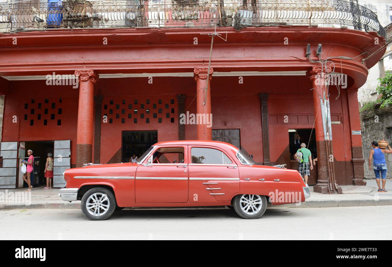 A 1954 Red Ford car by a Red building in Havana, Cuba Stock Photo - Alamy