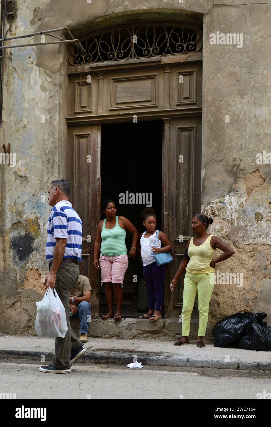 Locals sitting on the street by their doorstep in old Havana, Cuba ...