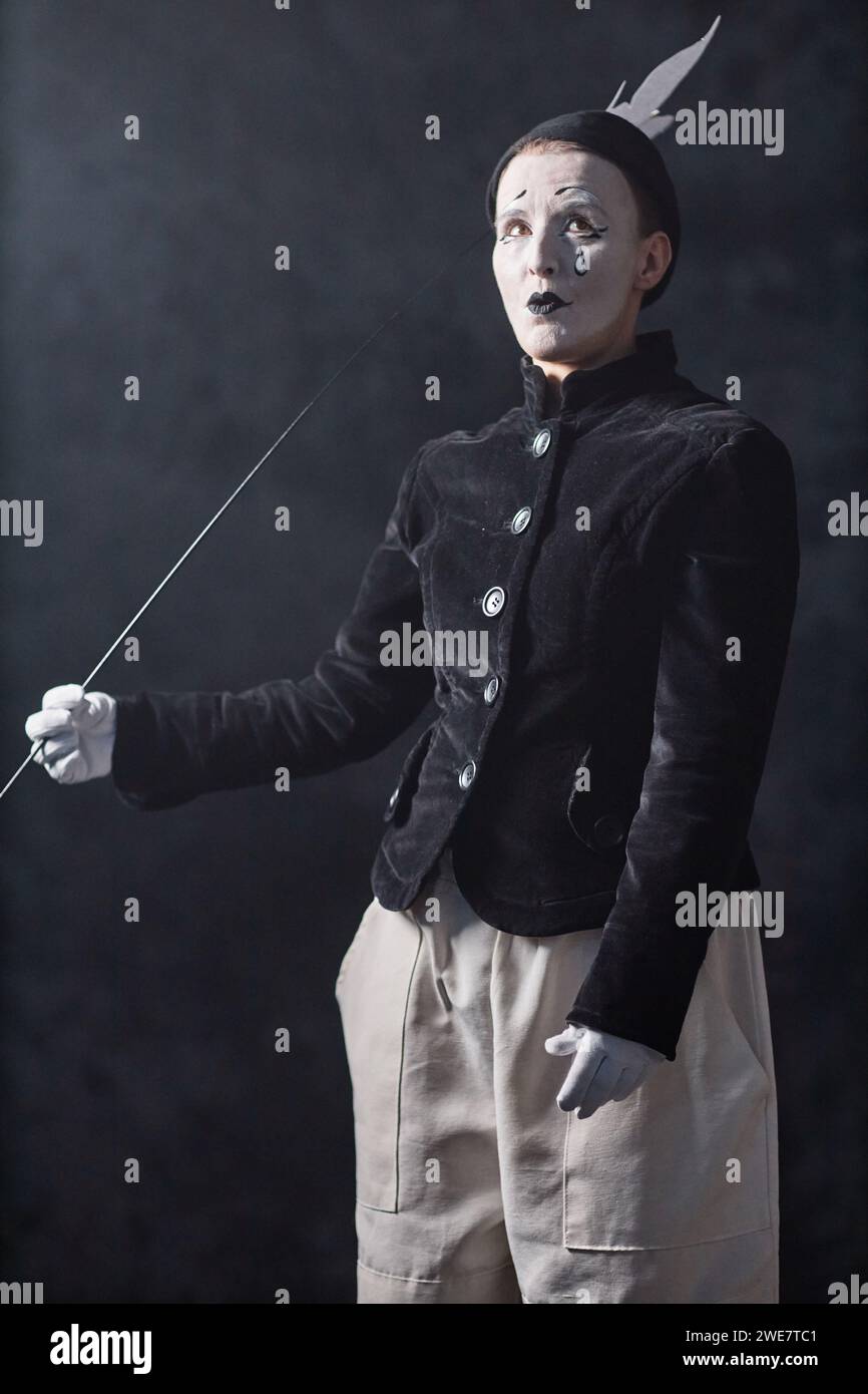 Vertical portrait of classic mime performer acting on stage in costume ...
