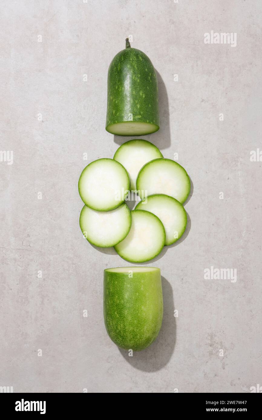 Winter melon round slices arranged in circle over a light background ...