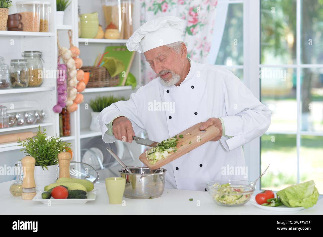 Portrait of chef preparing dinner at kitchen Stock Photo - Alamy