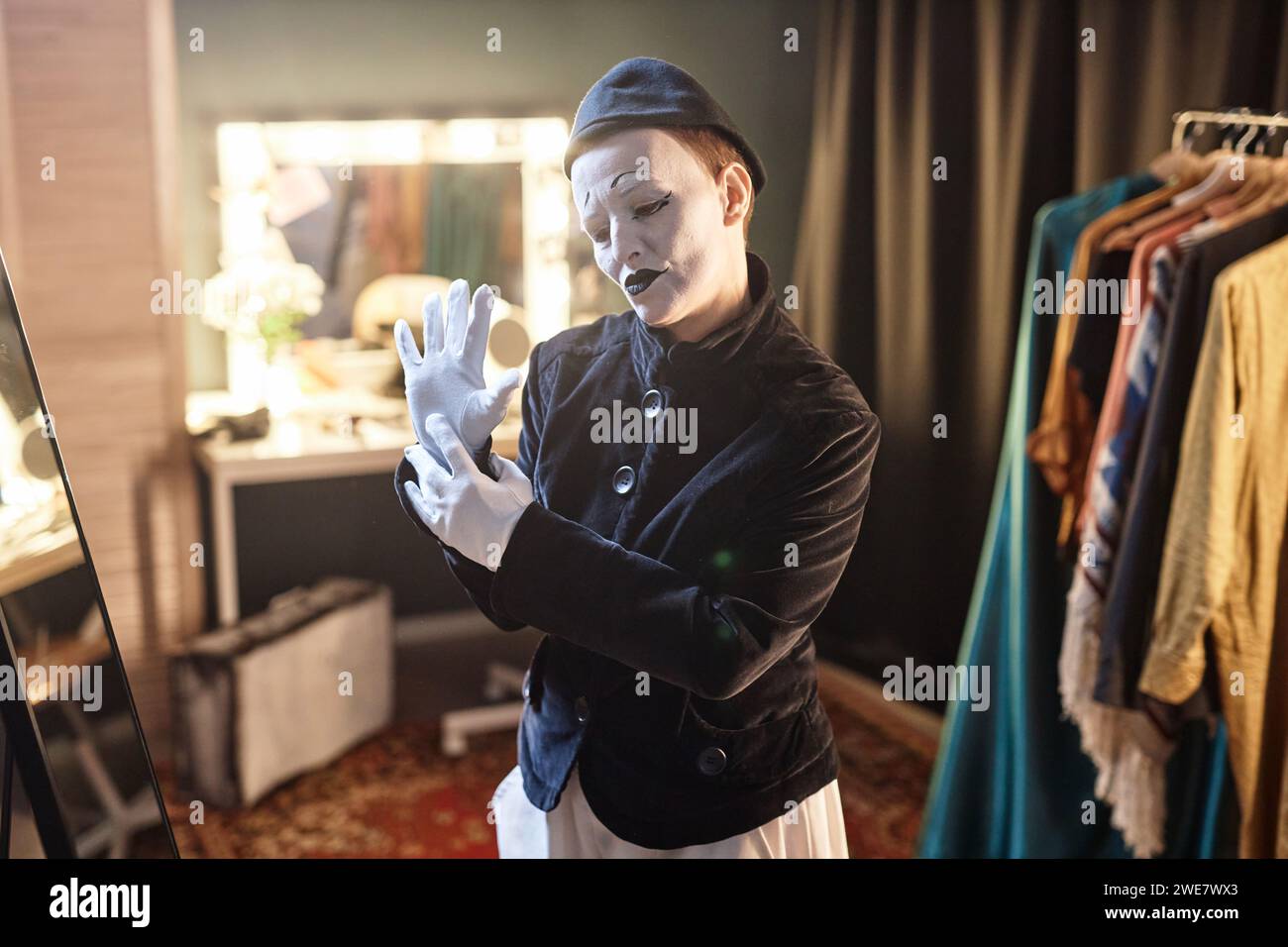 Waist up portrait of female mime performer dressing in costume ...