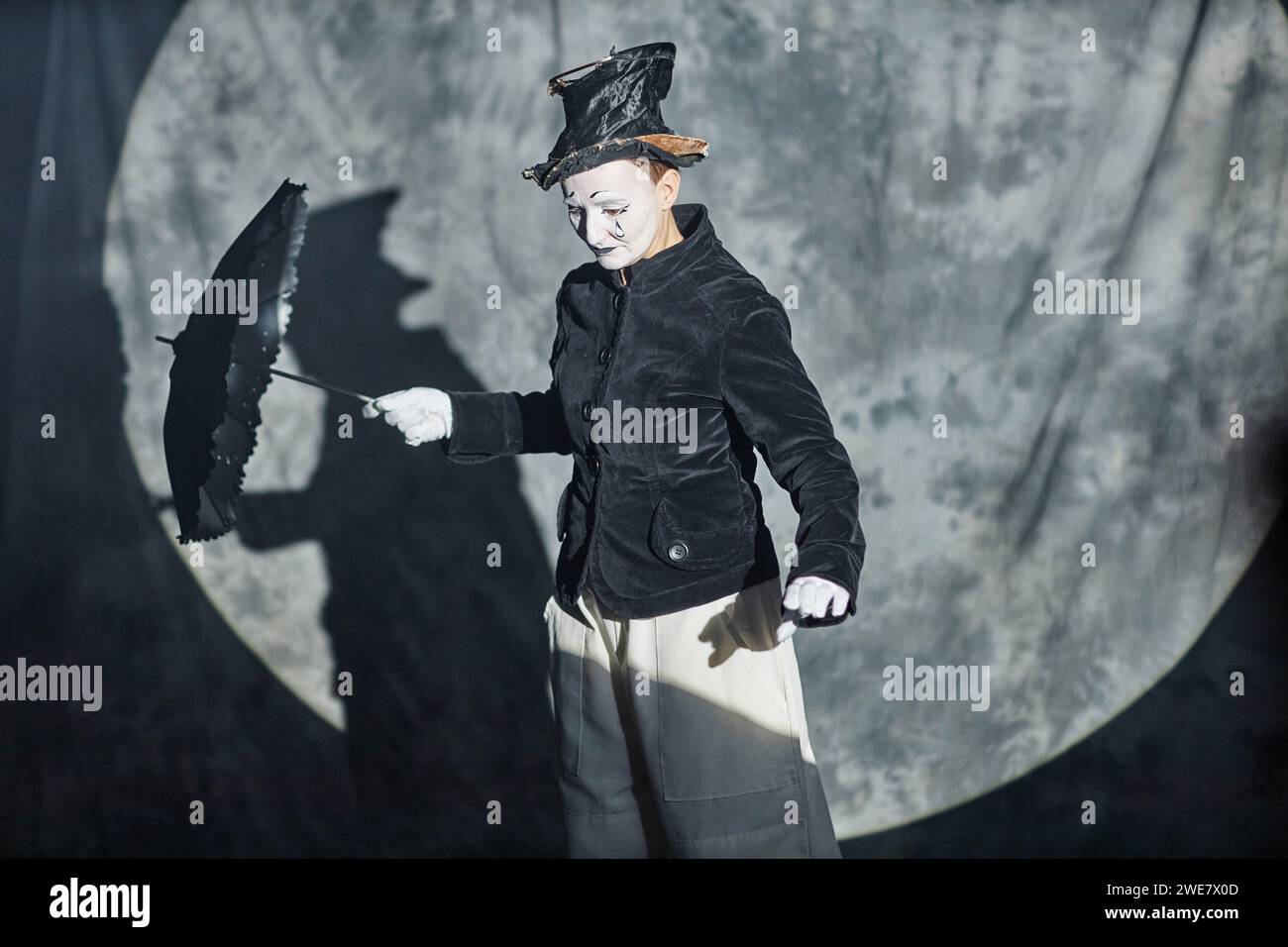 Waist Up Portrait Of Classic Mime Performer Acting On Stage In Spotlight With Umbrella Copy