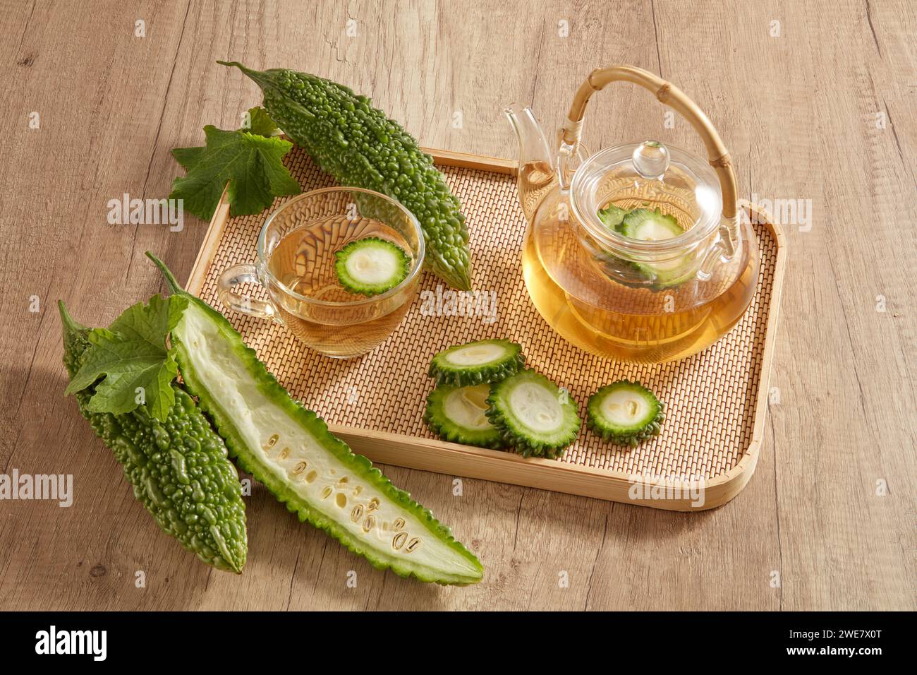 On the bamboo tray featured a transparent tea set with bitter melon ...