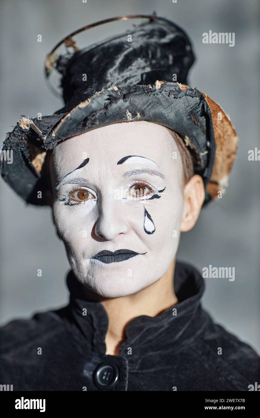 Vertical closeup portrait of female mime performer looking at camera ...