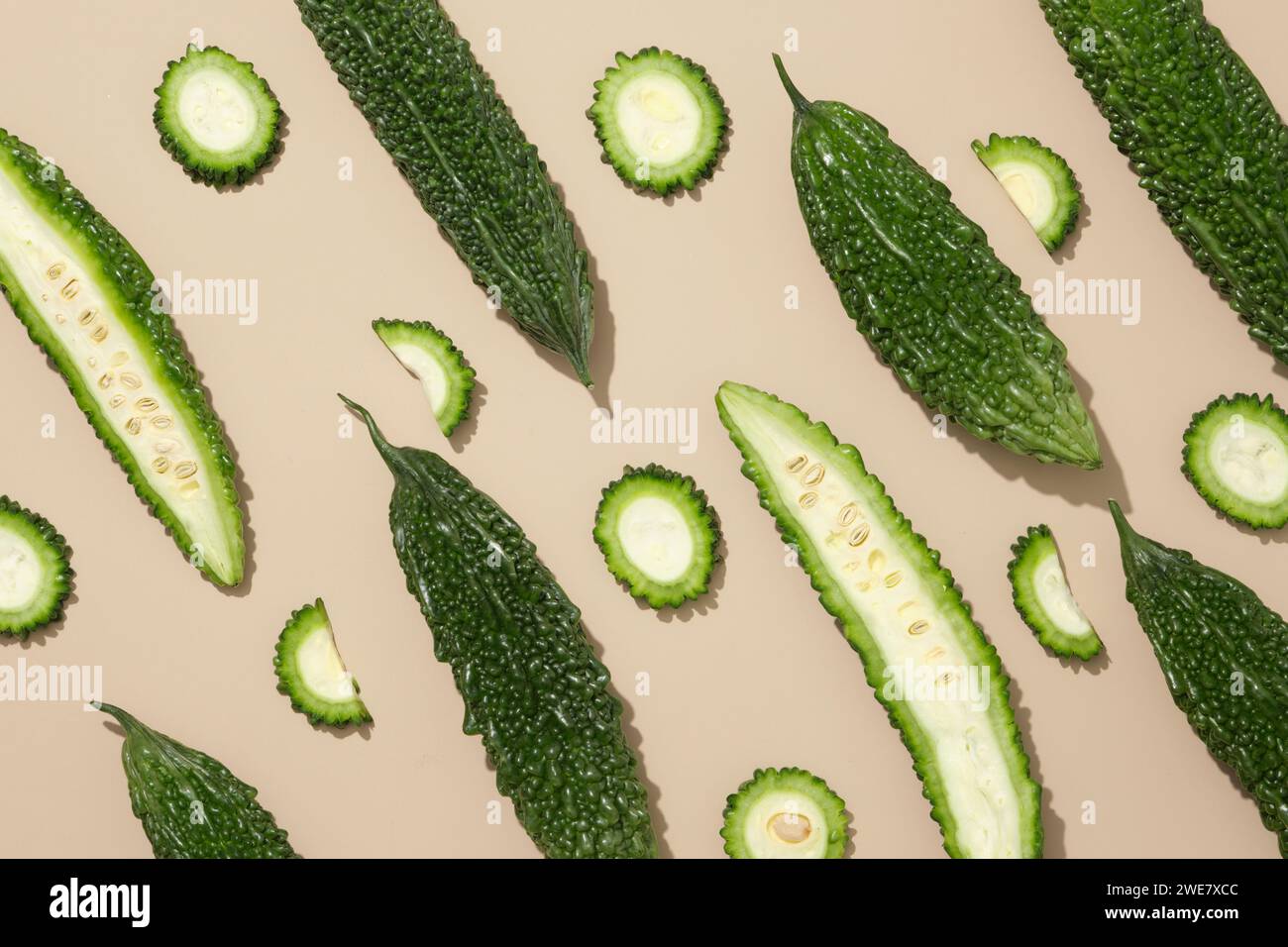 Many bitter melon cut in half and slices are arranged on the background ...