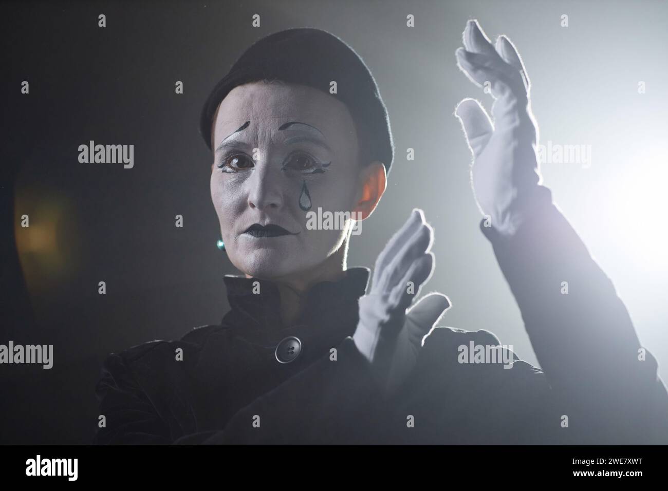 Dramatic portrait of sad mime artist with tear makeup performing on ...
