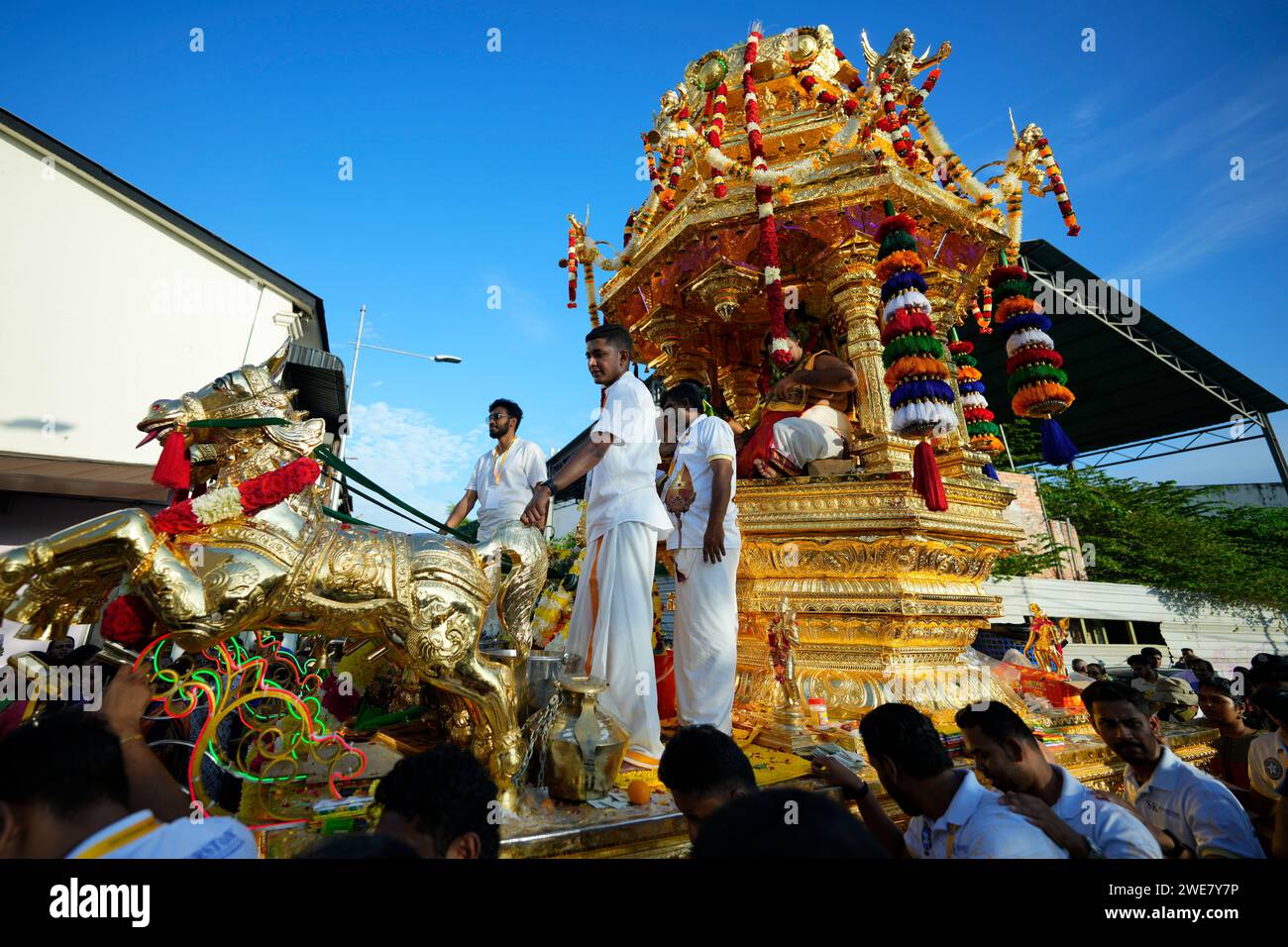 Hindu devotees parade the gold chariot bearing the idol of Hindu god ...