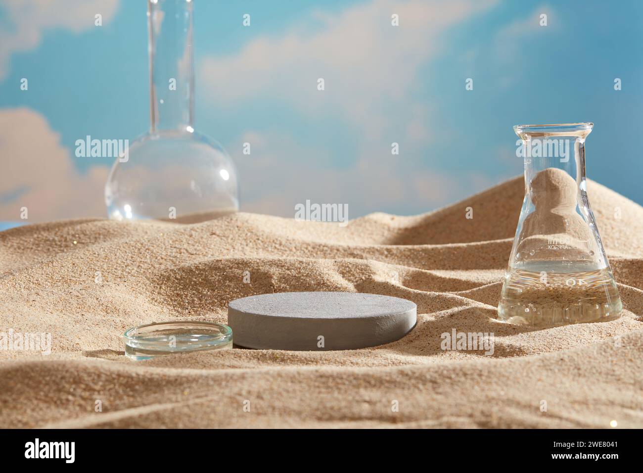 Laboratory concept on the the beach sand with a round podium in gray ...