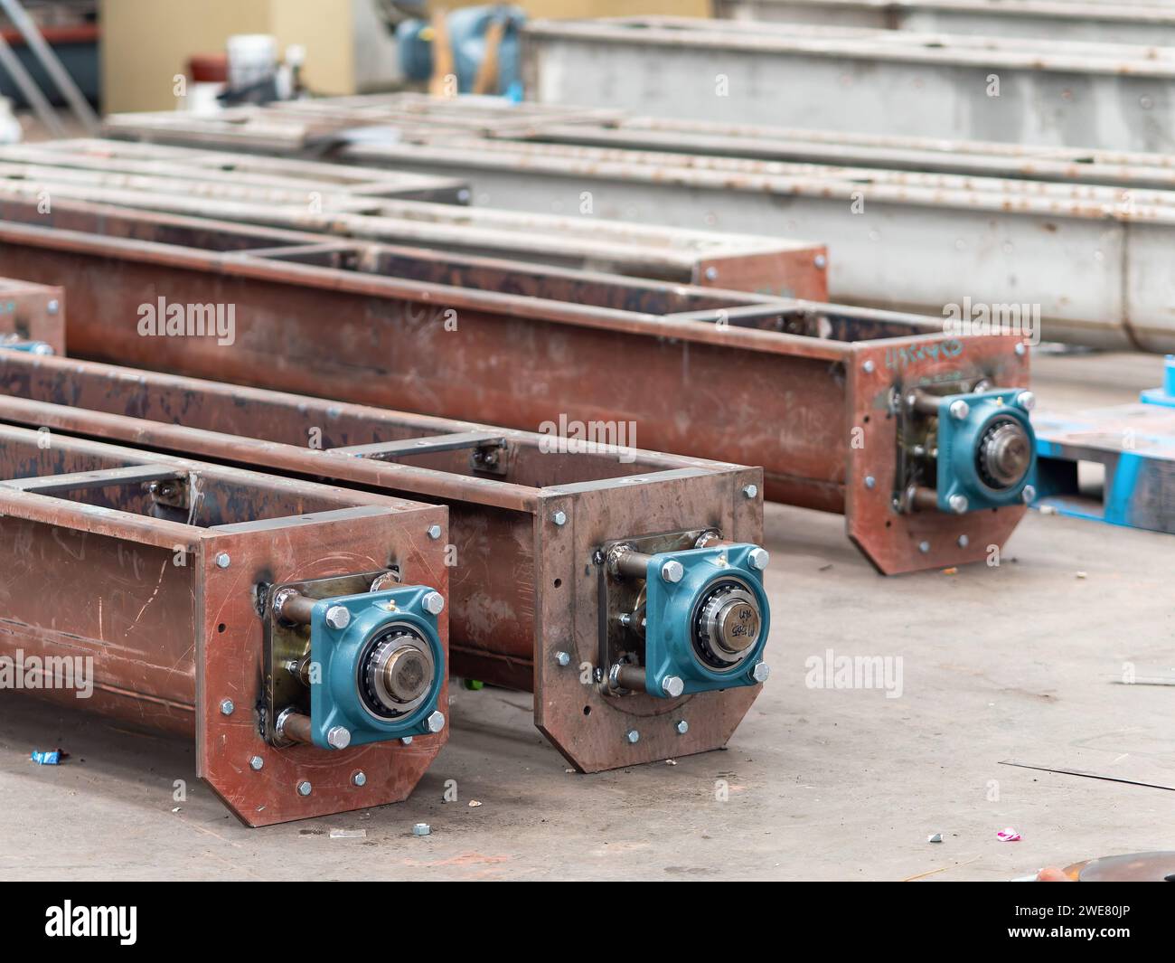 Screw conveyor with ball bearings during manufacturing at an industrial ...