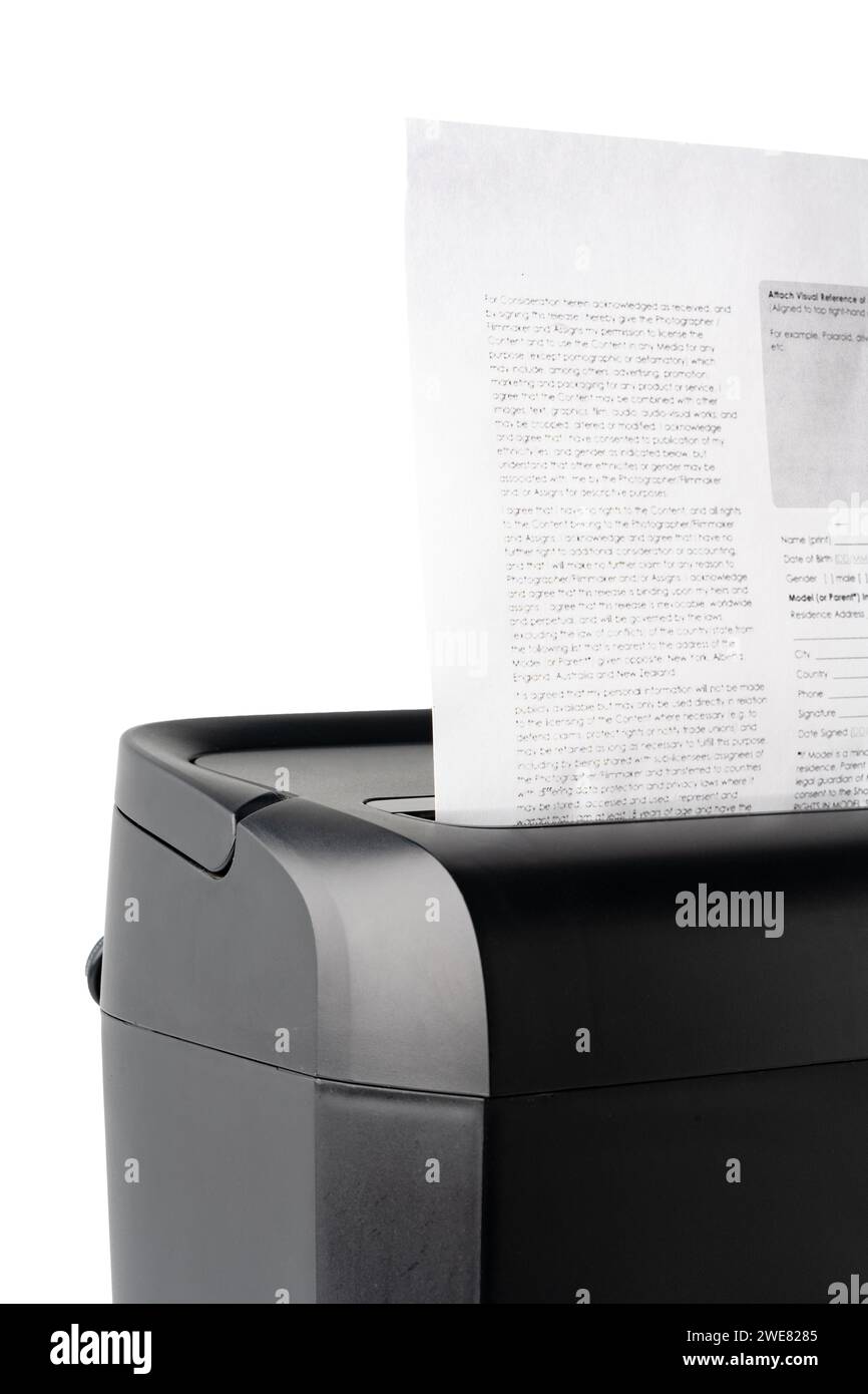 Office paper shredder on table against gray background Stock Photo - Alamy