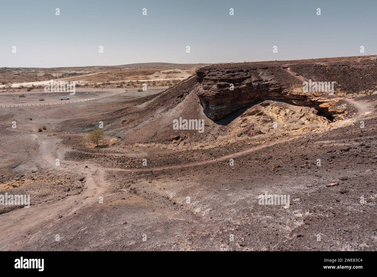 hot day landscape of volcanic formation of black burnt mountain in ...