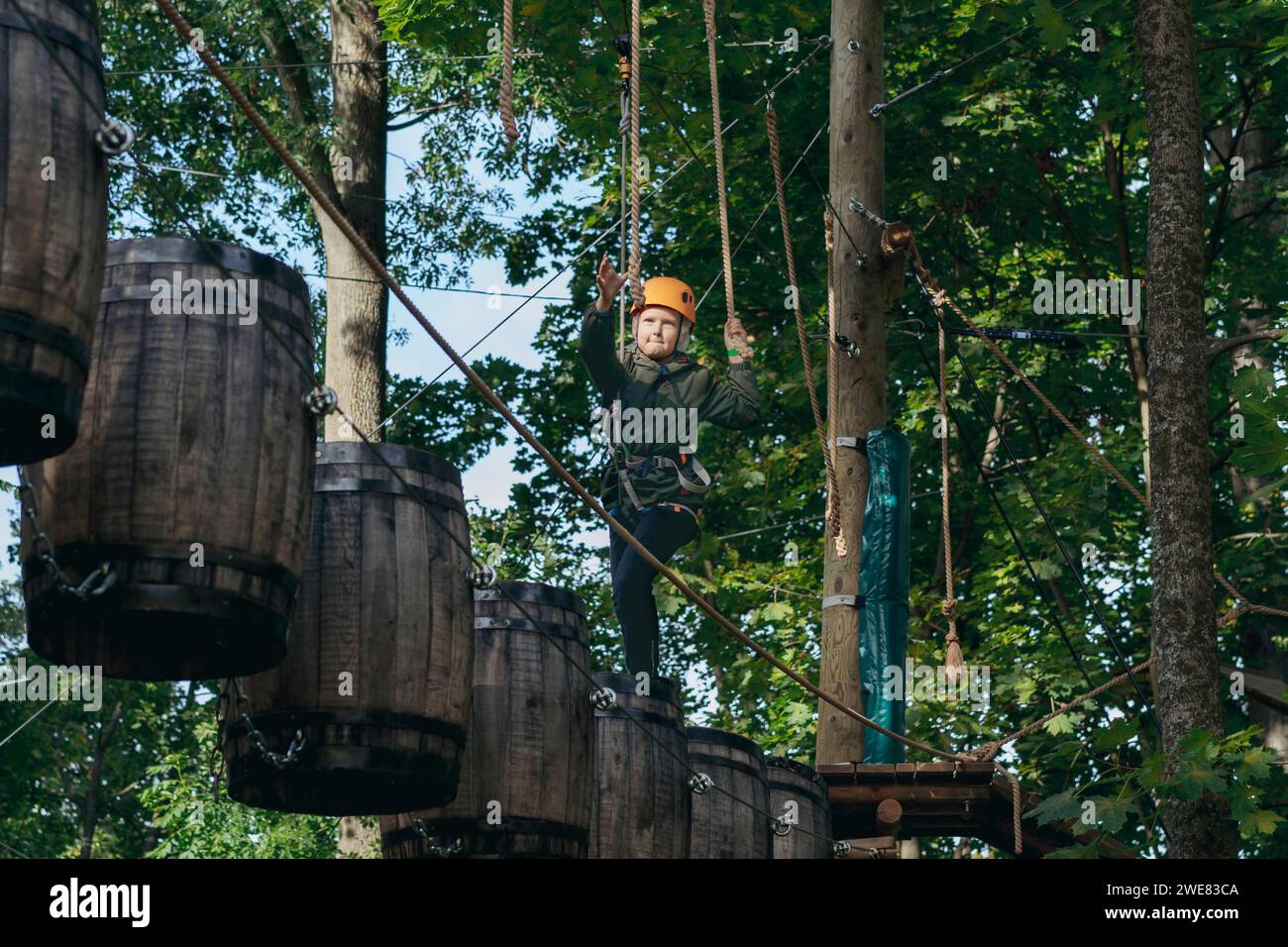 well equipped teenage boy in outdoor passing obstacle course. Active ...
