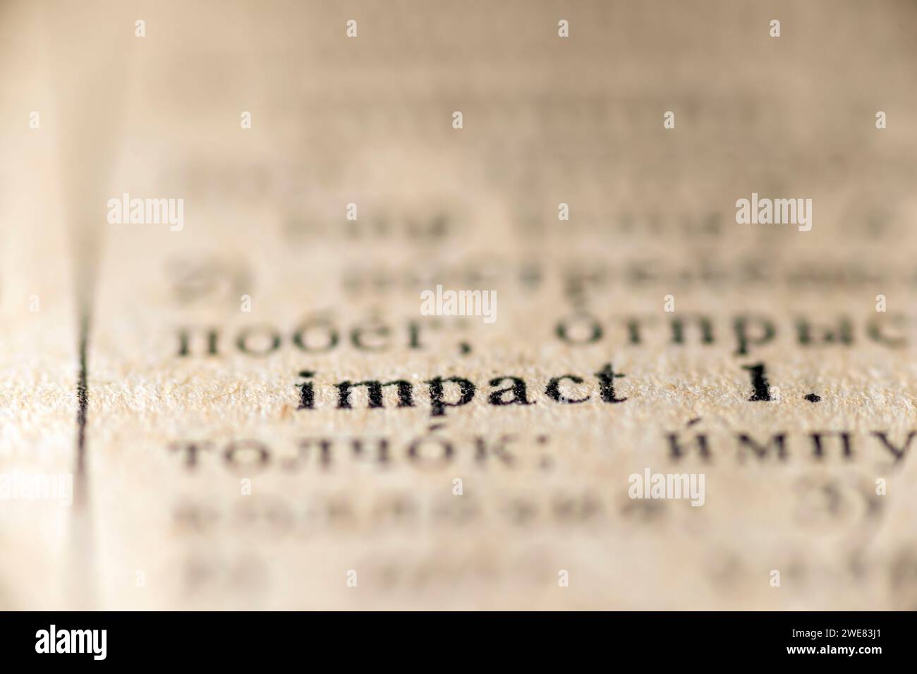 focus on impact word printed inside vintage dictionary Stock Photo - Alamy
