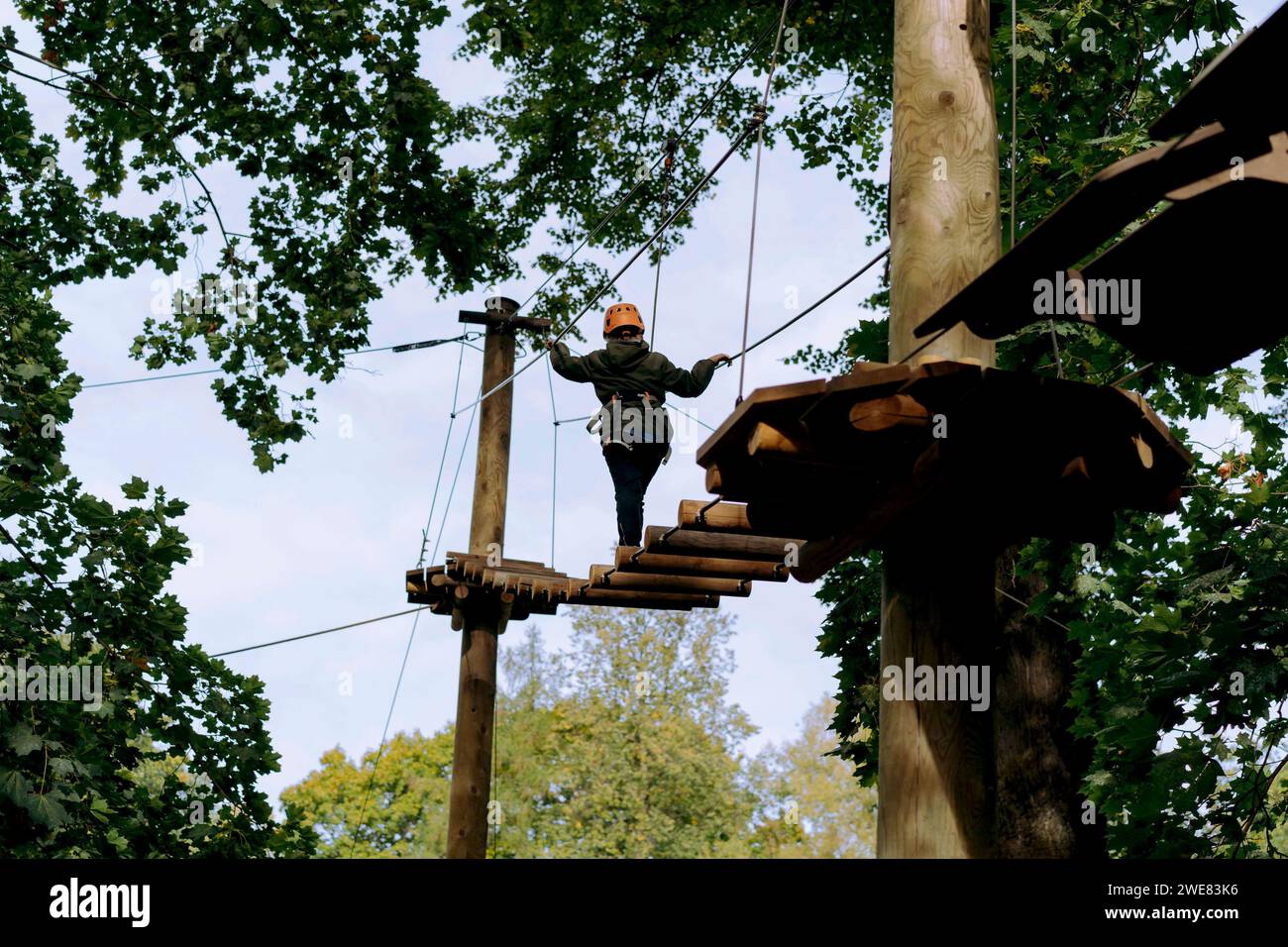 well equipped teenage boy in outdoor passing obstacle course. Active ...