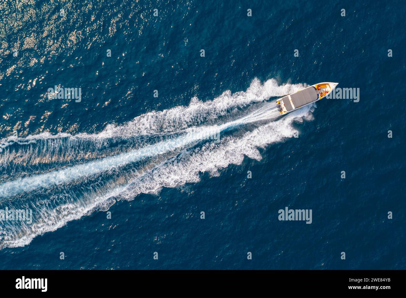 High speed boat rushing along the water surface of warm tropical waters ...