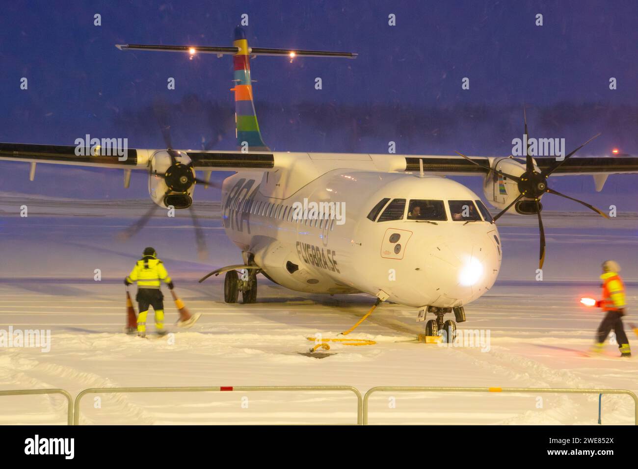 Braathens airline ATR-72-600 aircraft taxiing in heavy snow. Passenger ...