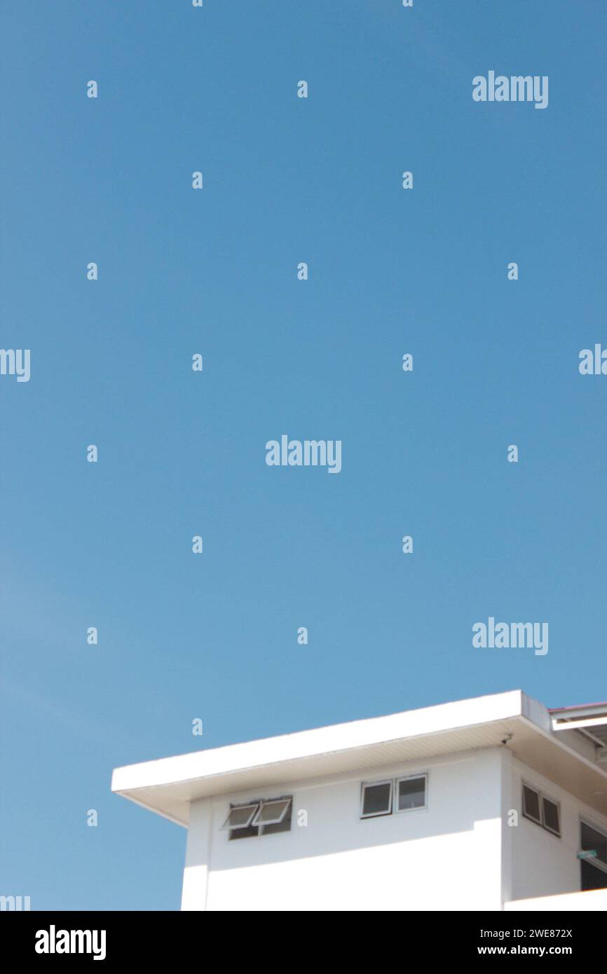 White modern building with clear blue skies Stock Photo - Alamy