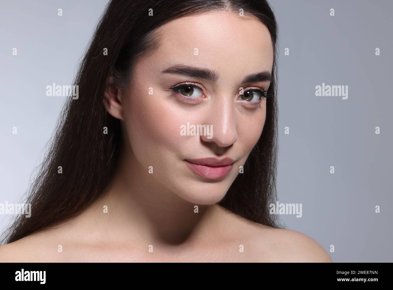 Portrait of beautiful young woman on grey background Stock Photo - Alamy