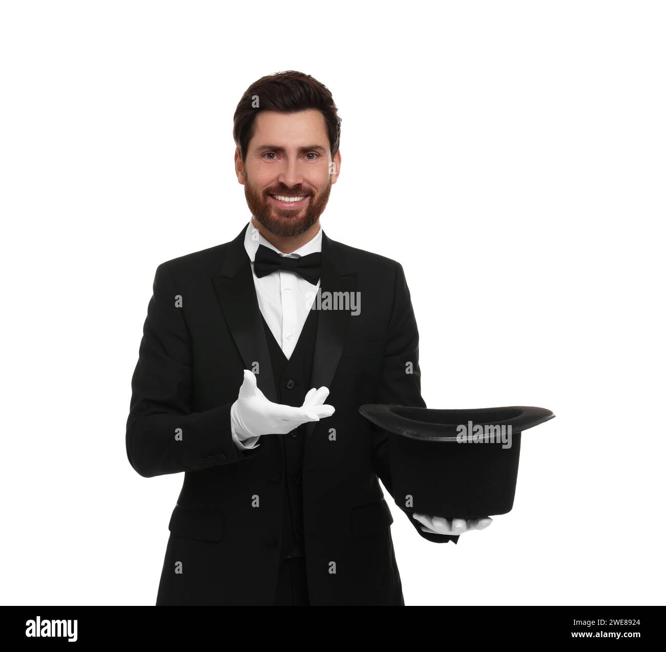 Happy magician holding top hat on white background Stock Photo - Alamy