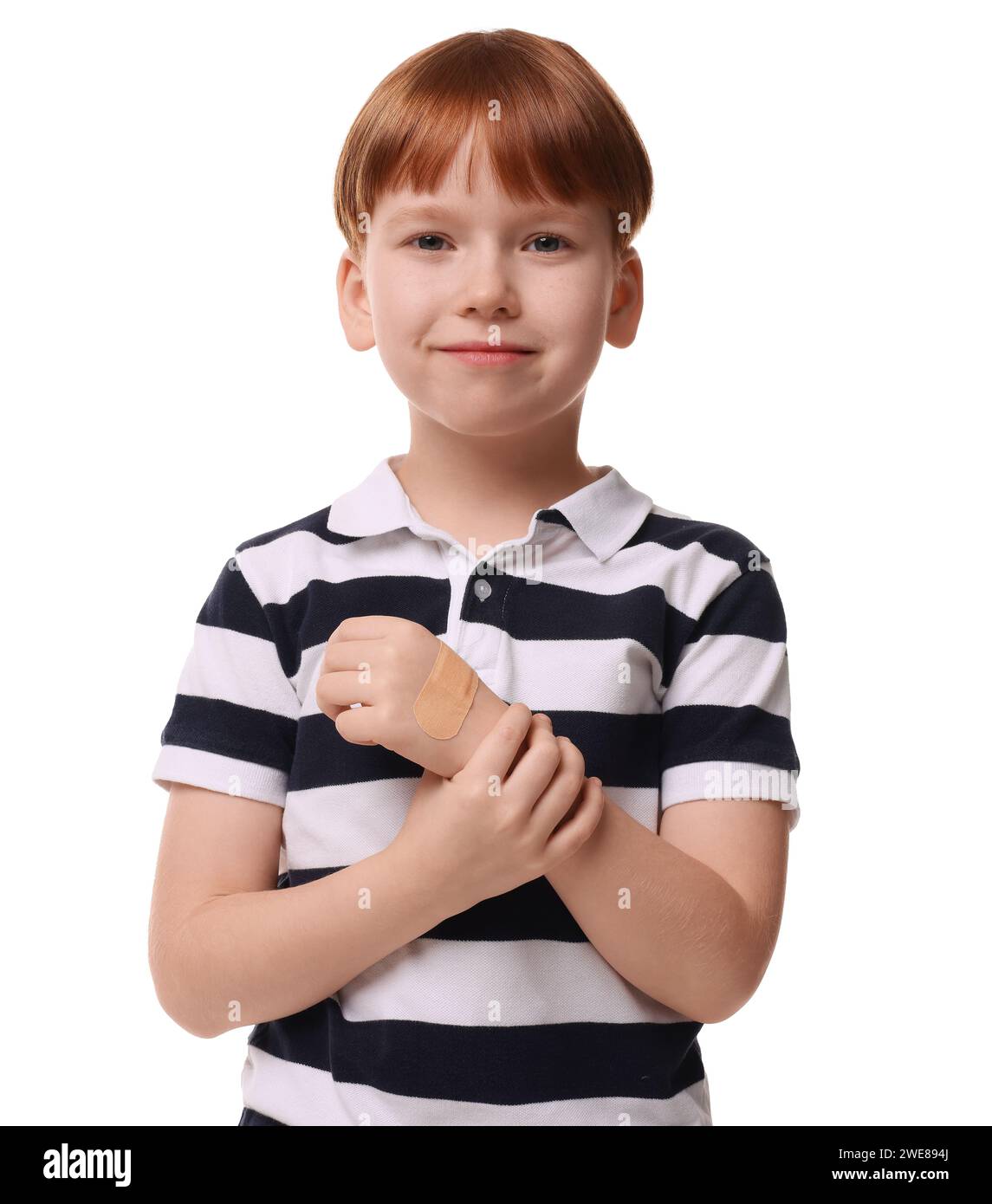 Little boy with sticking plaster on hand against light blue background ...