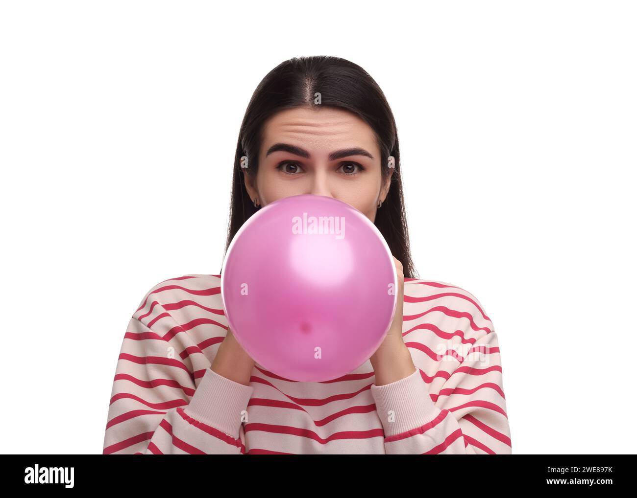Woman inflating pink balloon on white background Stock Photo - Alamy