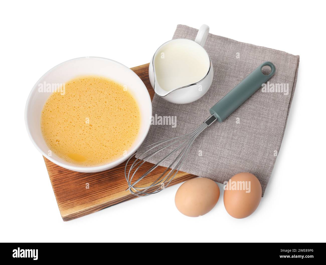 Metal whisk, beaten eggs and milk isolated on white Stock Photo - Alamy