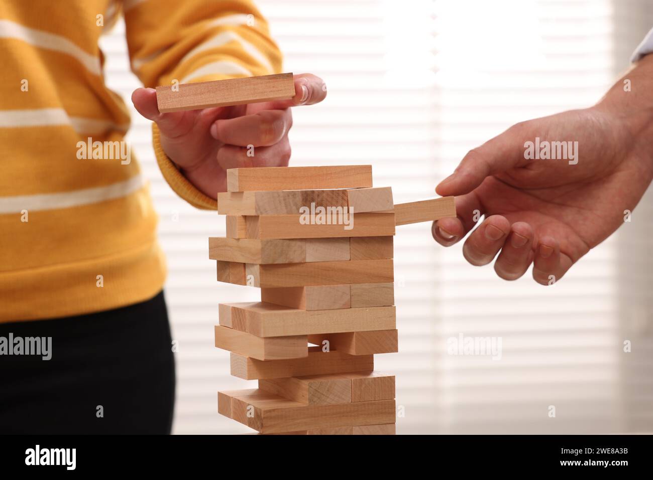 People playing Jenga tower at home, closeup Stock Photo - Alamy