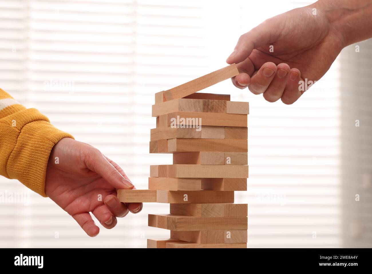 People playing Jenga tower at home, closeup Stock Photo - Alamy