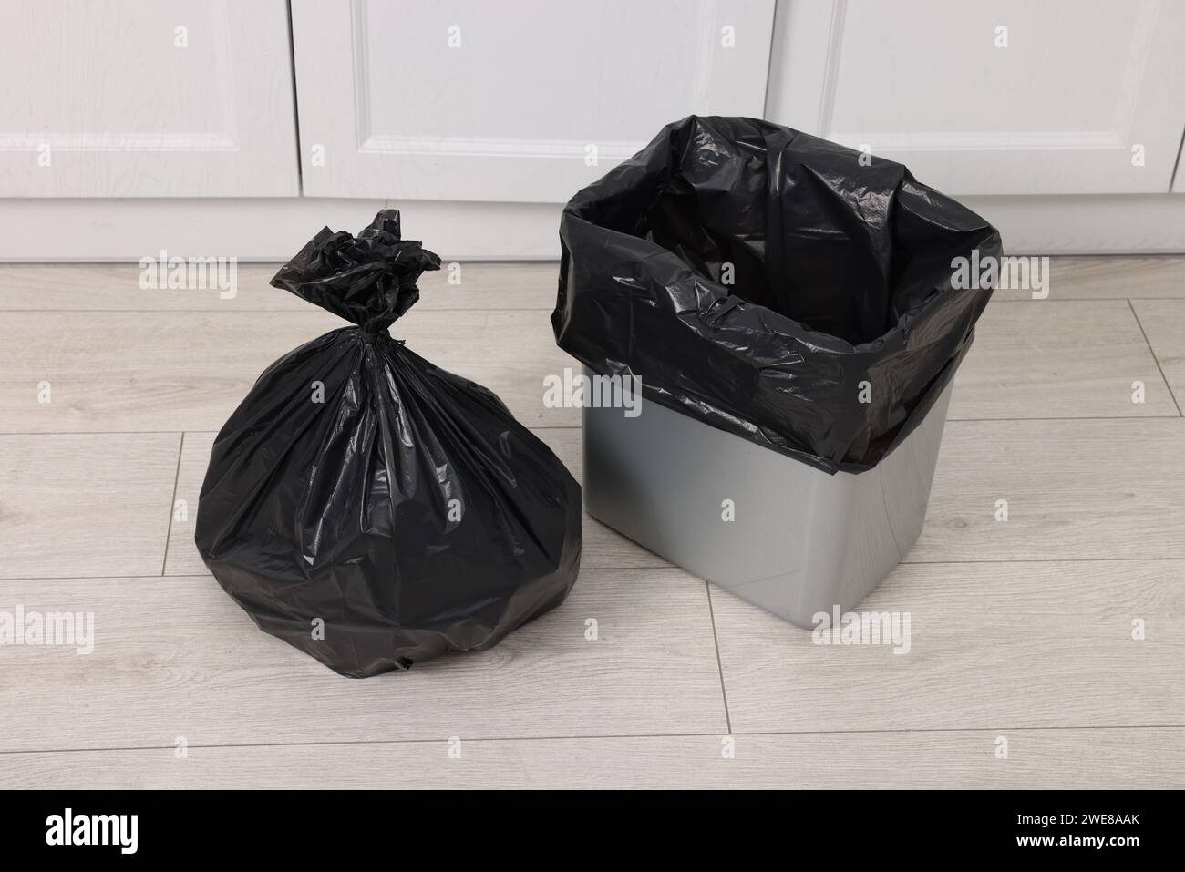 Plastic garbage bag and trash can indoors Stock Photo - Alamy