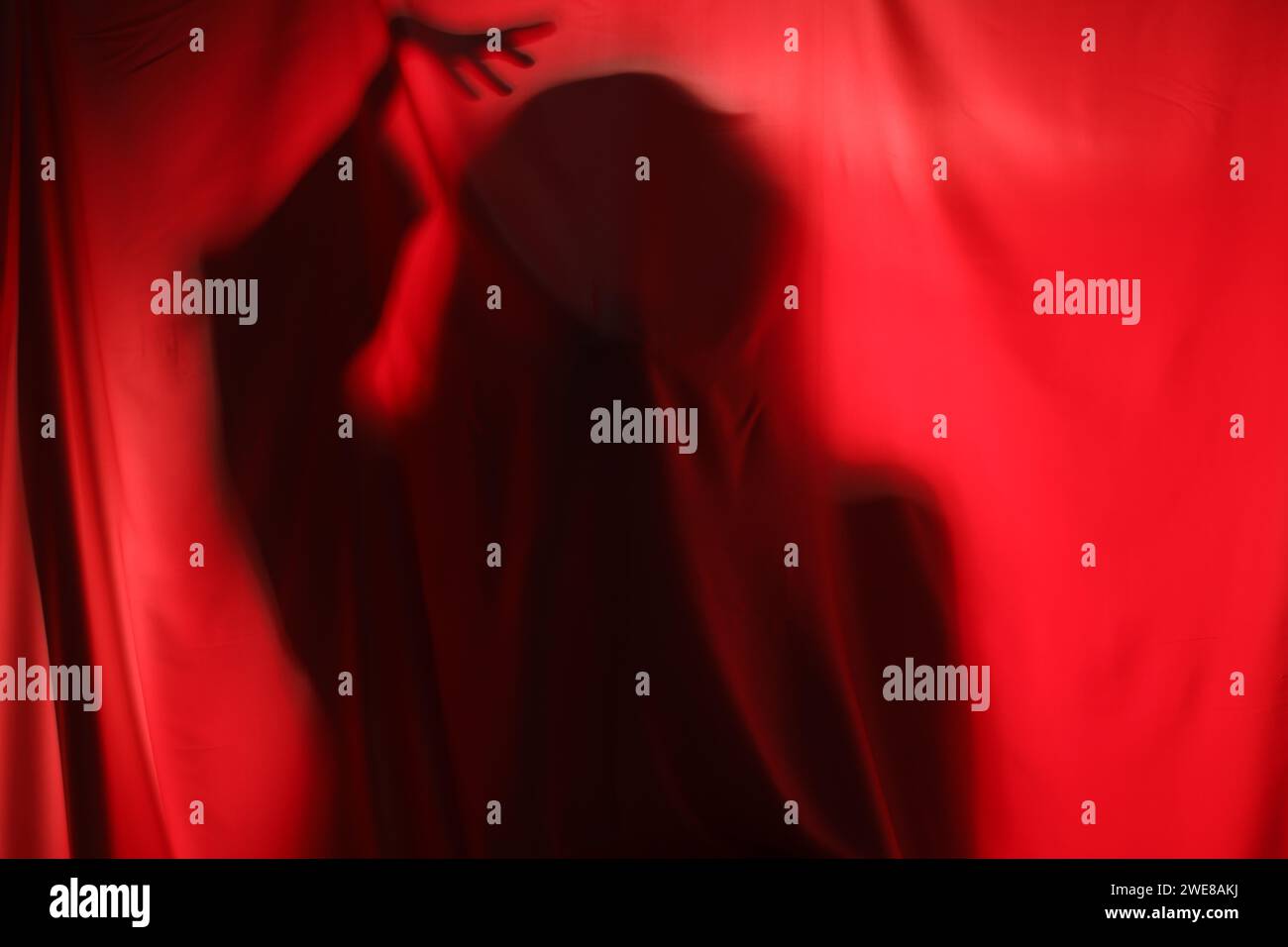 Silhouette of creepy ghost behind red cloth Stock Photo - Alamy