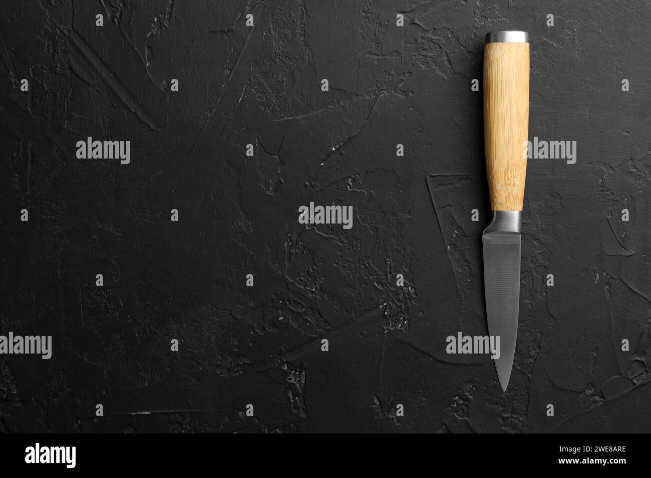 One sharp knife on dark textured table, top view. Space for text Stock ...