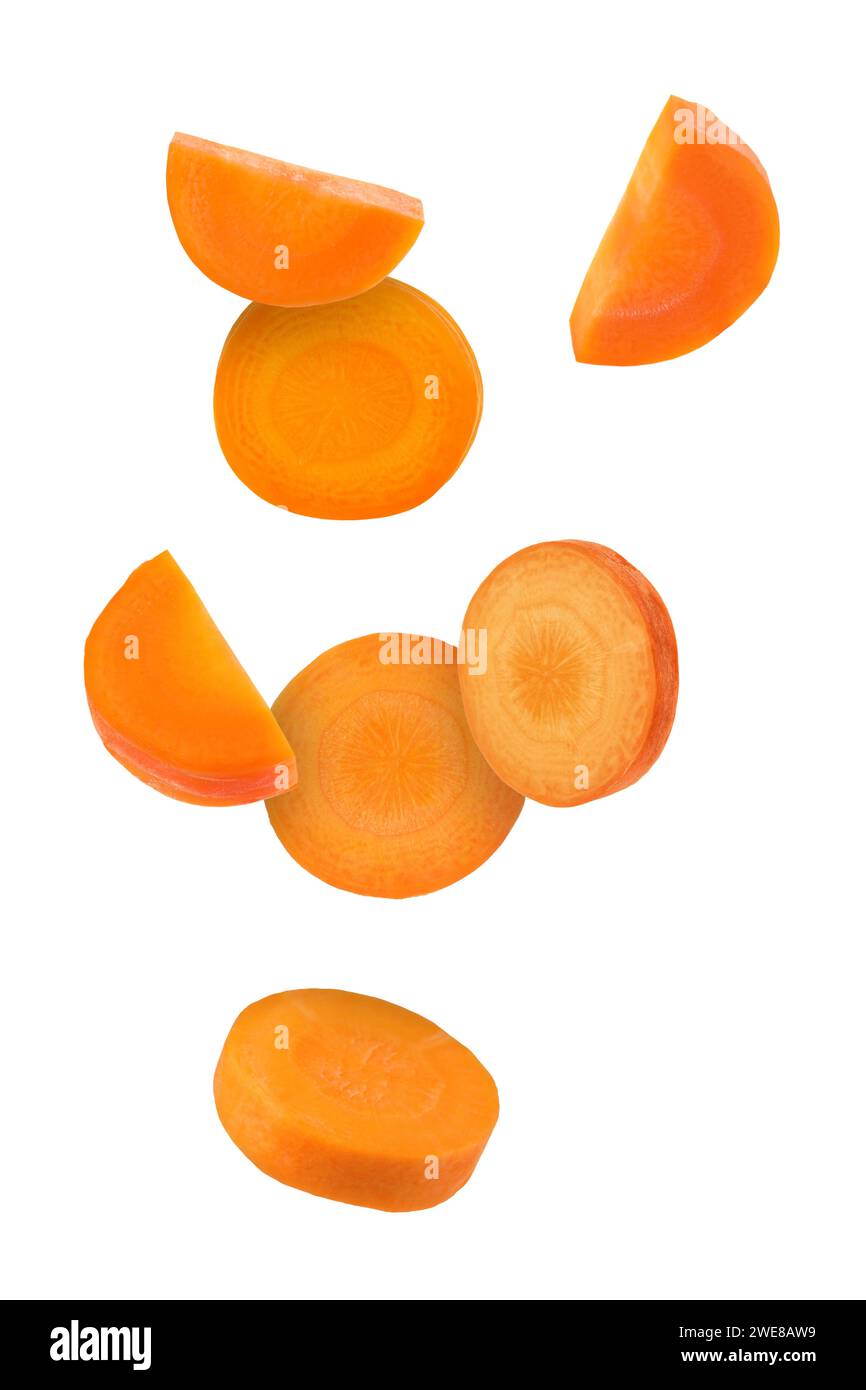 Fresh carrot slices falling on white background Stock Photo - Alamy