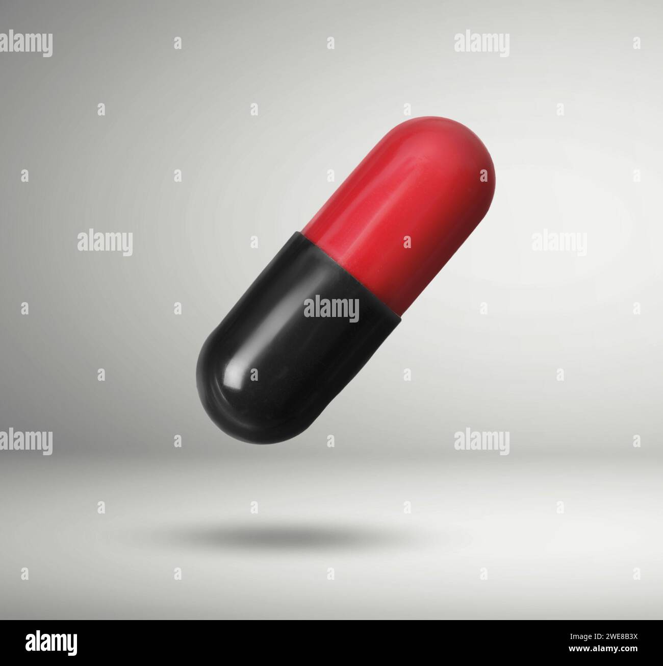 Colorful vitamin capsule in air on light grey background Stock Photo ...
