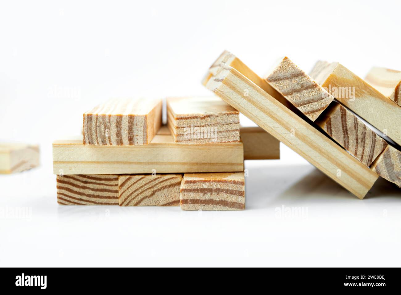 Closeup view of the tower of the wooden block falling on a white ...