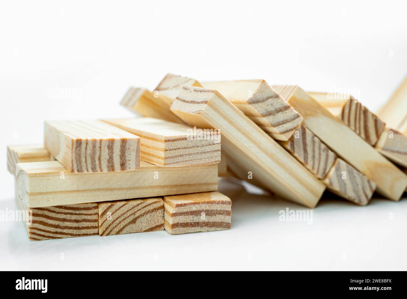 Closeup view of the tower of the wooden block falling on a white ...