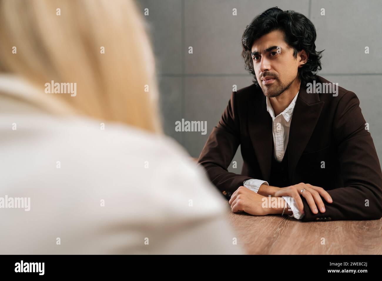 Back view of unrecognizable businesswoman having meeting with serious ...