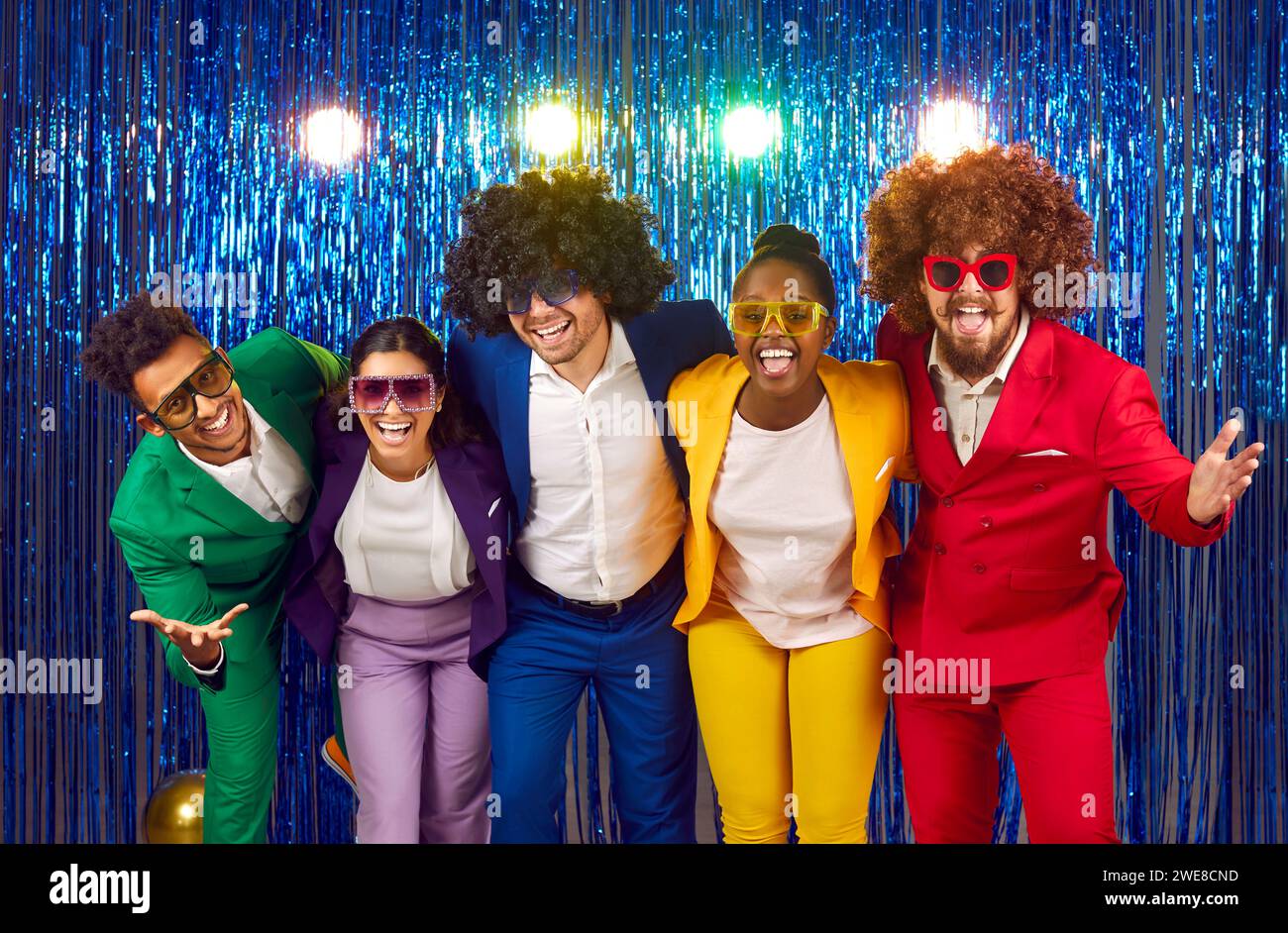 Funny cheerful group of happy young people dressed in bright costumes ...