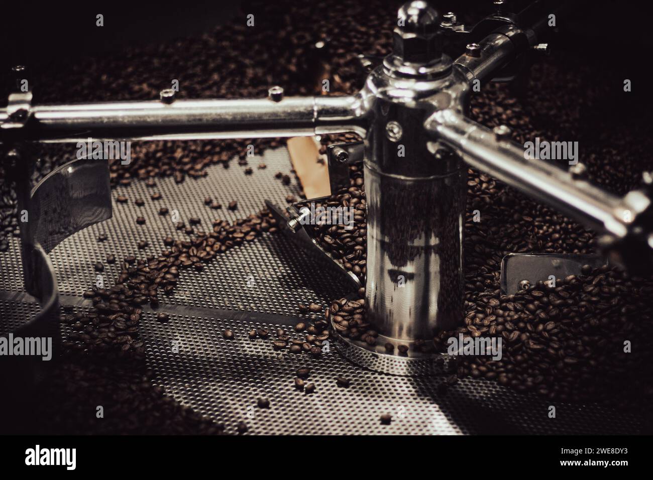Close up of beans in a stainless steel industrial coffee roaster for an ...