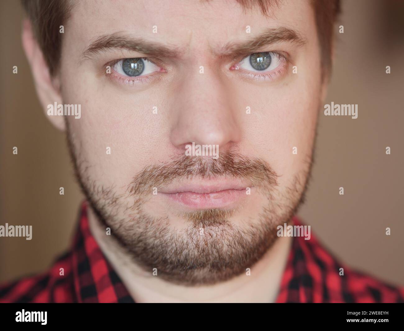 Sad young man, portrait on the beige background Stock Photo - Alamy