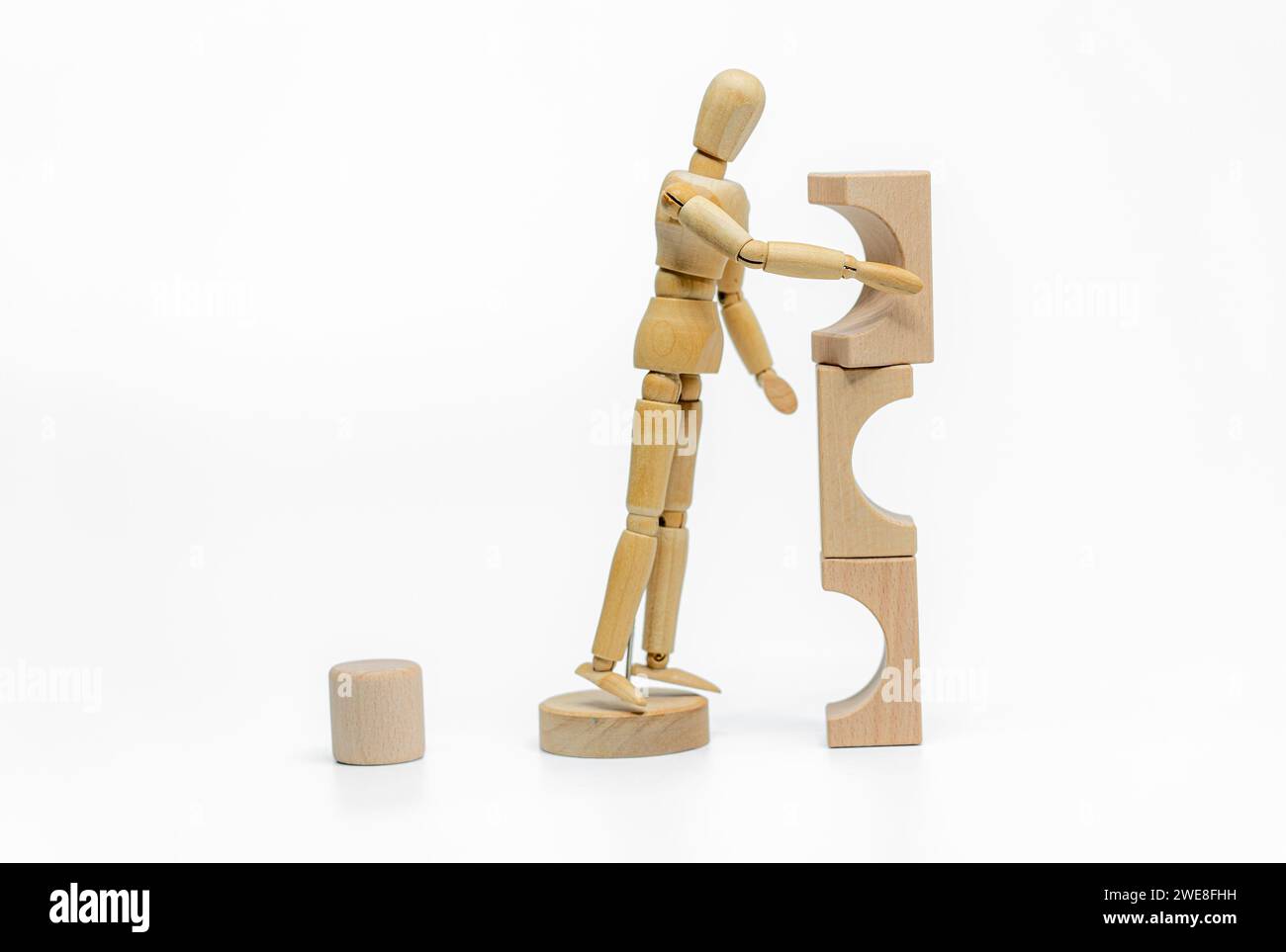 Wooden doll with wooden toy block isolated on white background ...