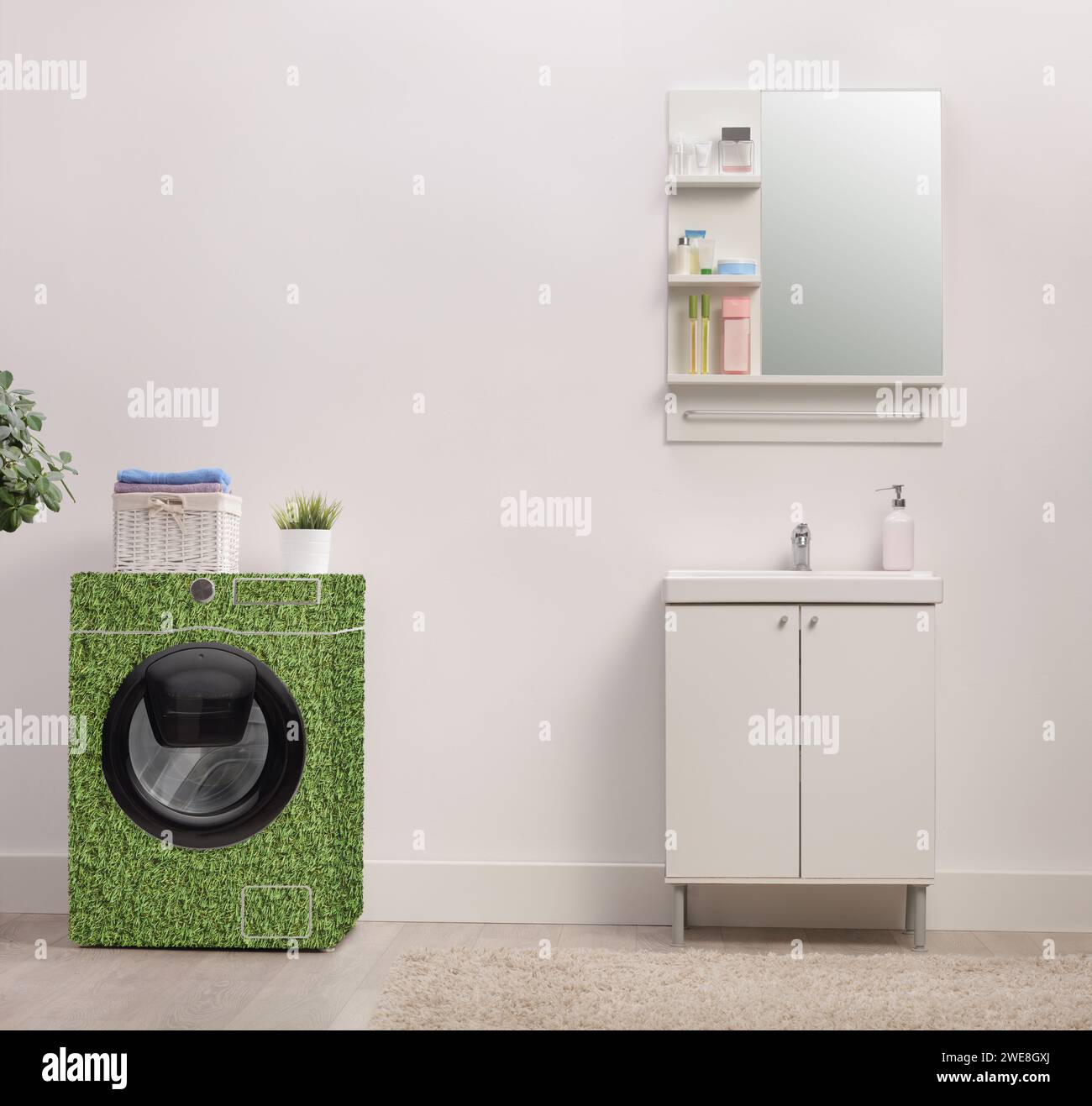 Energy efficient green washing machine in a bathroom next to a sink ...