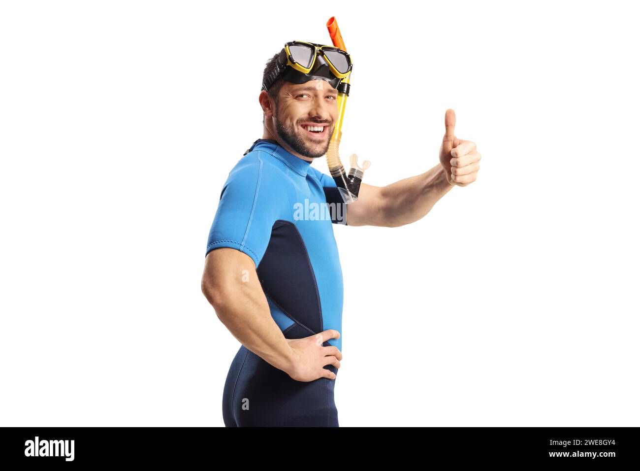 Young man in a diving suit putting on mask and gesturing thumbs up ...