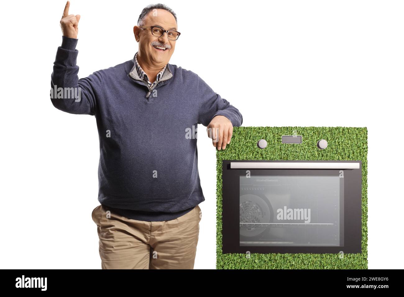 Smiling mature man with an energy efficient stove pointing up isolated ...