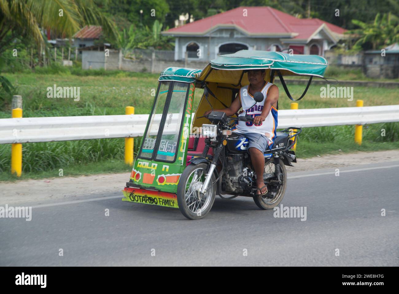 Three-wheeled vehicles on the road, called Tatlong-wiler motorized ...