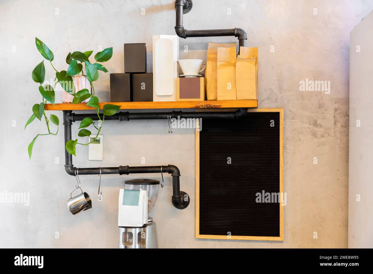 Boxes on a cafe shelf with an empty blackboard nearby Stock Photo - Alamy